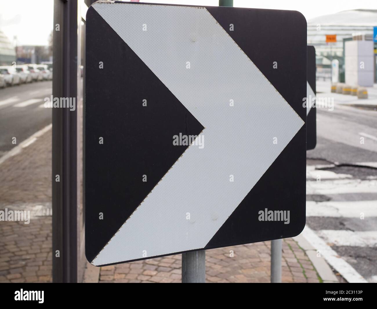 single black white chevron marker traffic sign Stock Photo - Alamy