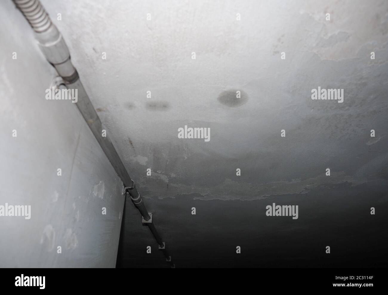 damage caused by dampness and moisture on a ceiling, with droplets of ...