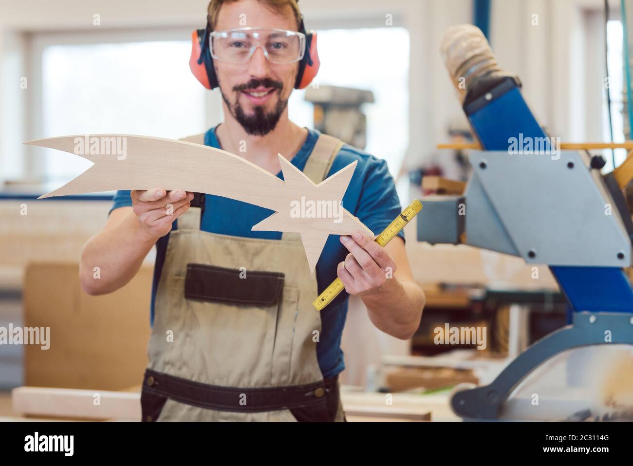 Carpenter doing woodworks for Christmas cutting a shooting star Stock ...