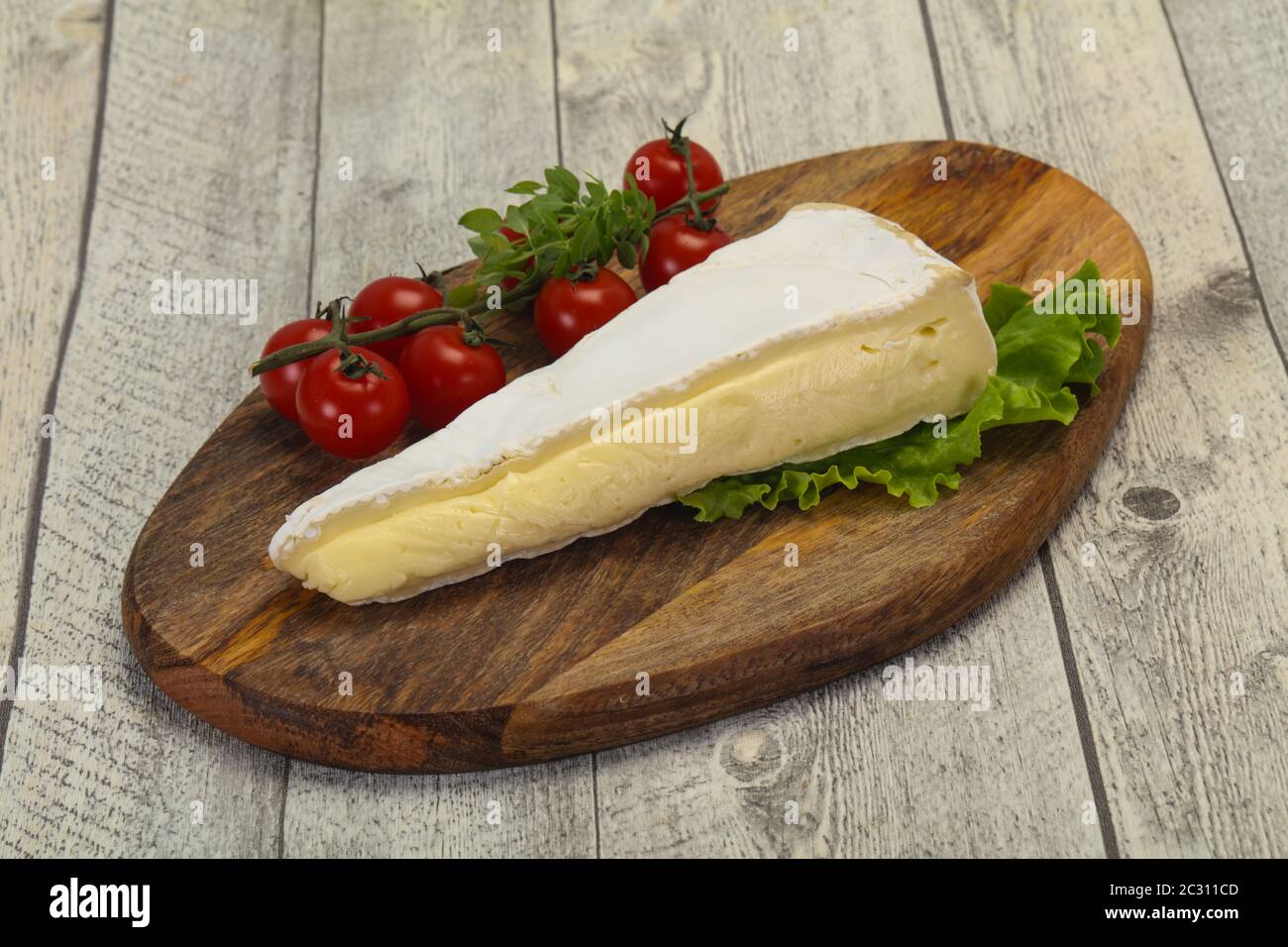 Brie cheese triangle served salad leaves Stock Photo - Alamy