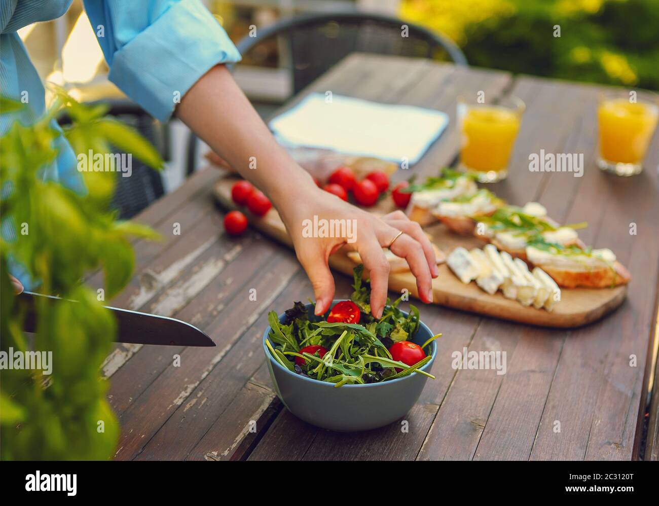 Young woman cooking dinner at the home in the garden Stock Photo - Alamy