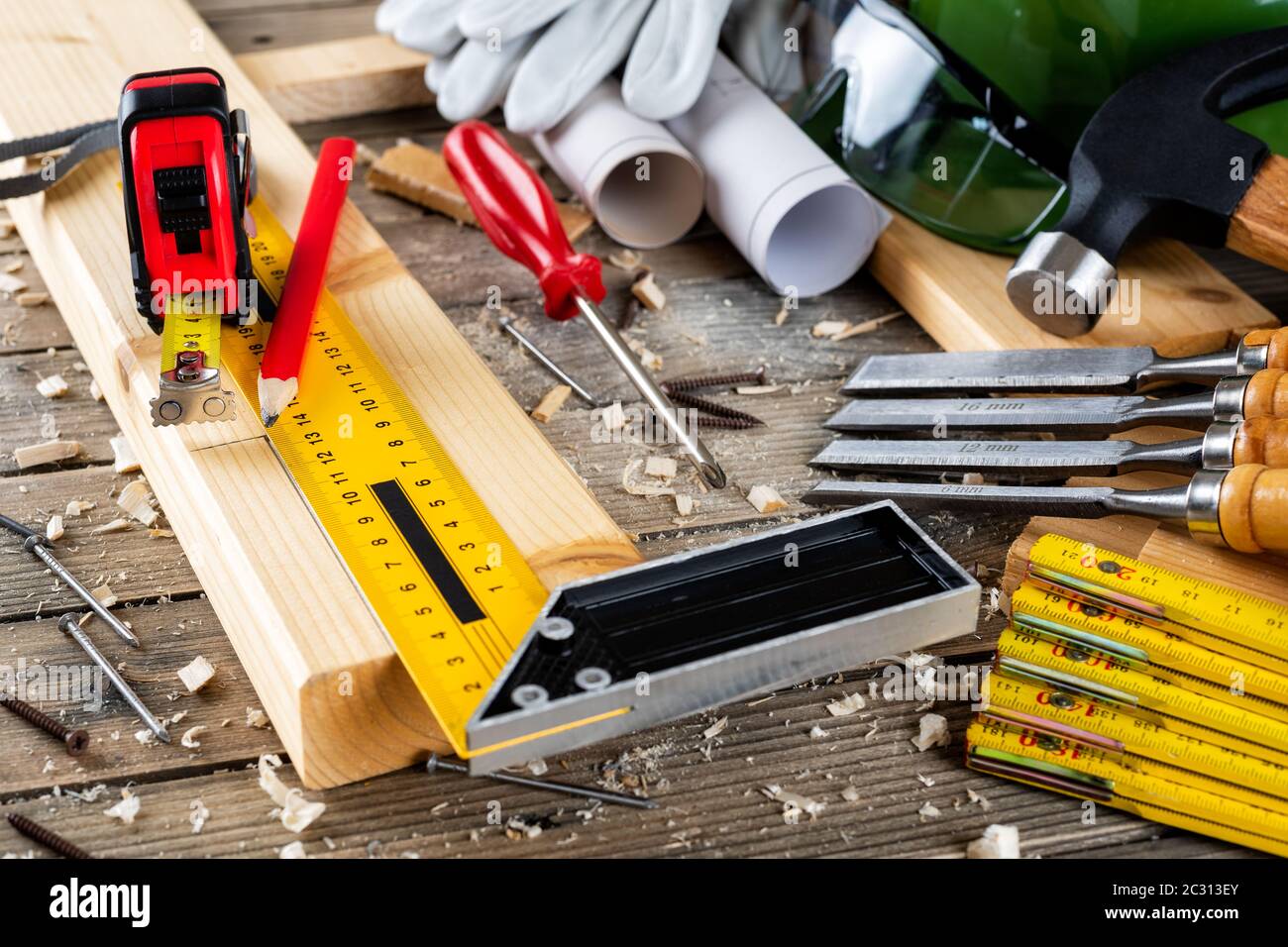 View from above of carpenter's tools on an antique wooden table ...