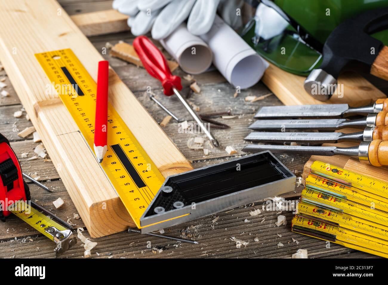 View from above of carpenter's tools on an antique wooden table ...