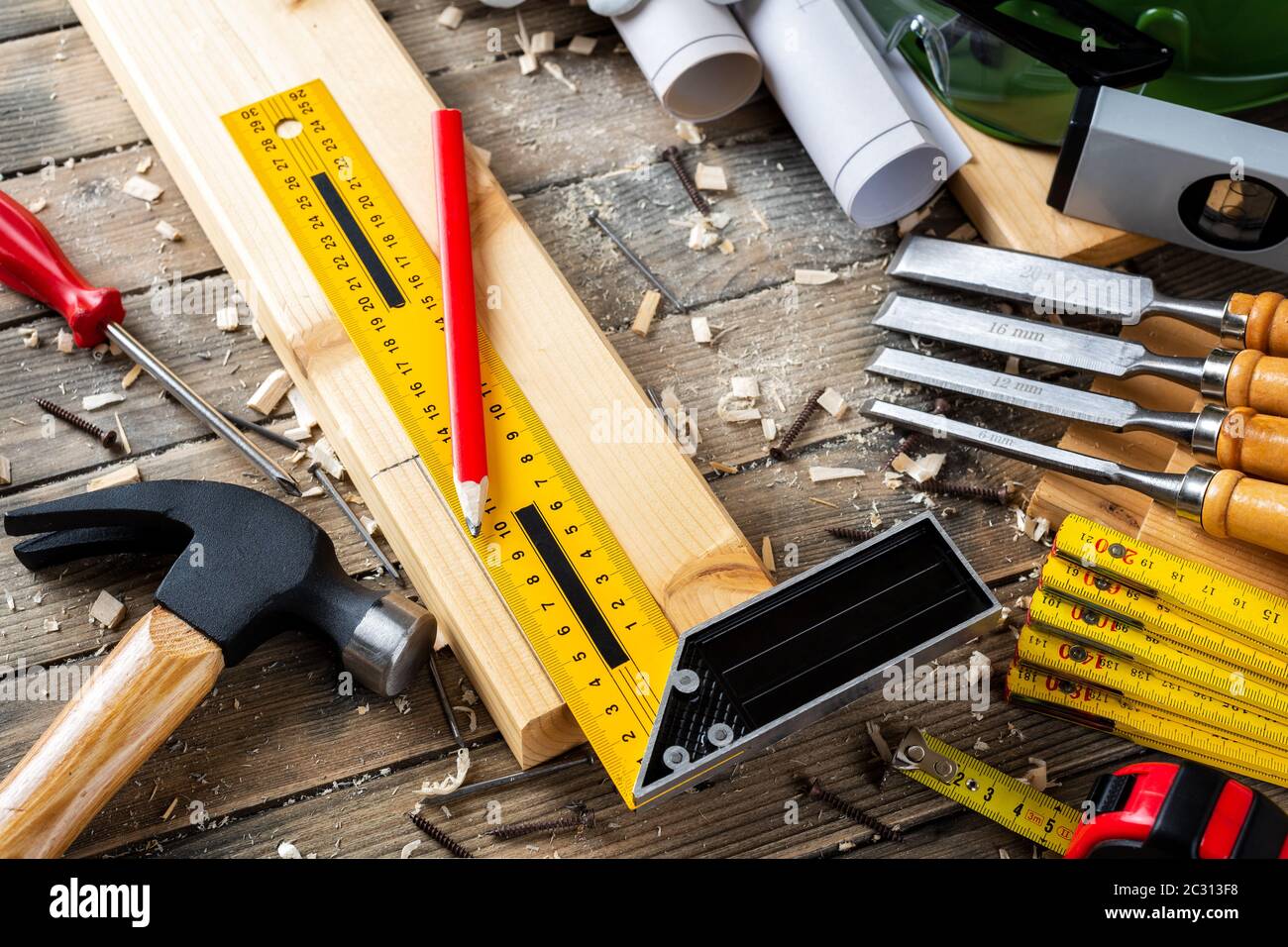View from above of carpenter's tools on an antique wooden table ...
