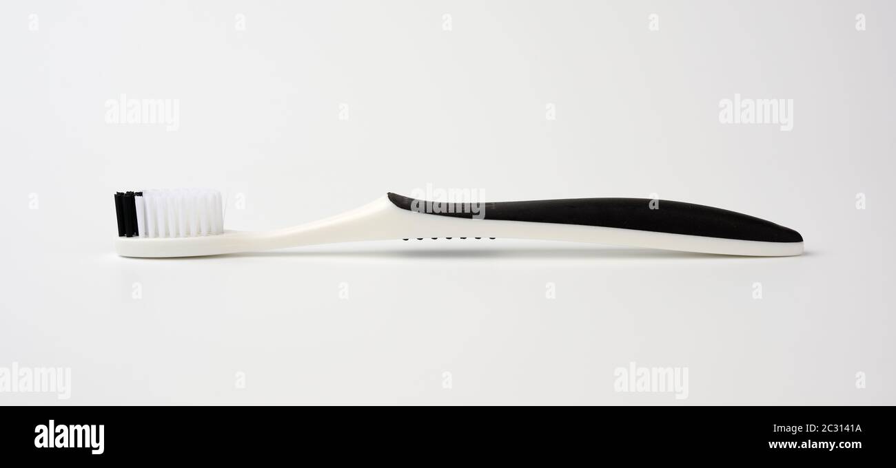 black plastic toothbrush for cleaning the oral cavity, object on a ...
