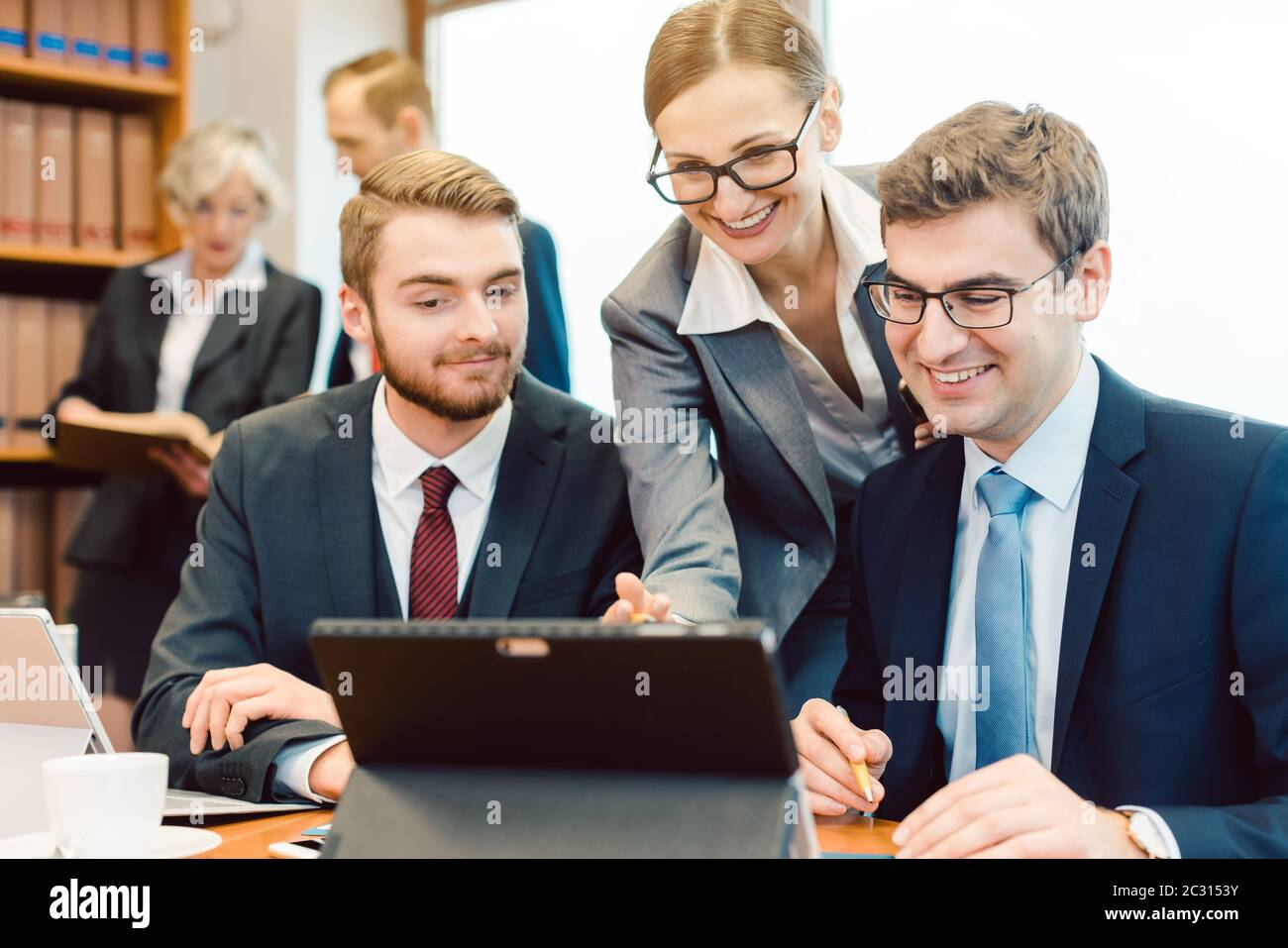 Young but diligent Lawyers in their law firm working on computer with ...