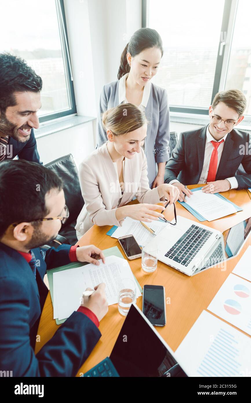 Five business people in a project meeting working together Stock Photo ...