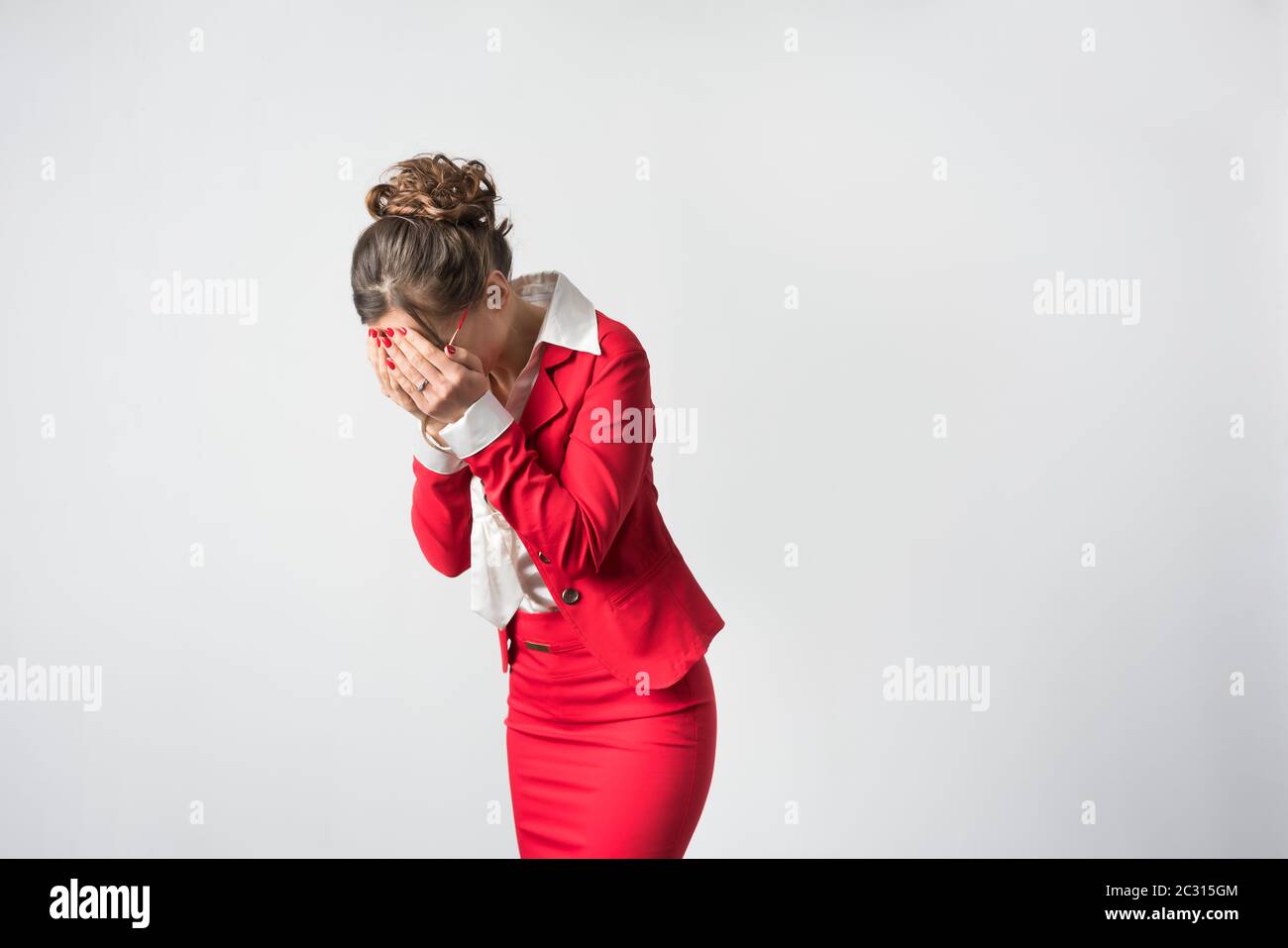 Overwhelmed businesswoman crying holding arms in front of her face ...