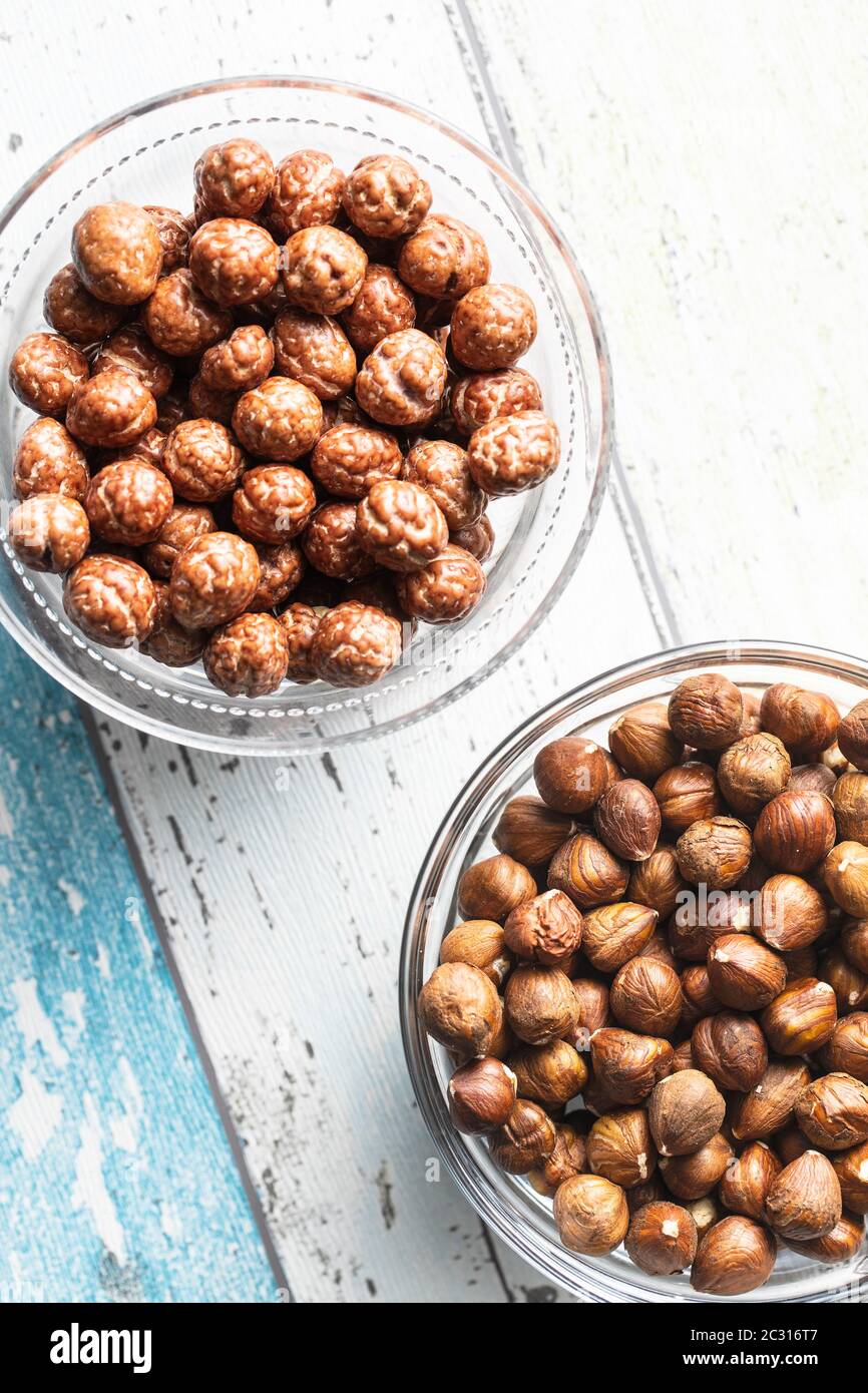 Hazelnuts with sugar icing in bowl. Top view Stock Photo - Alamy