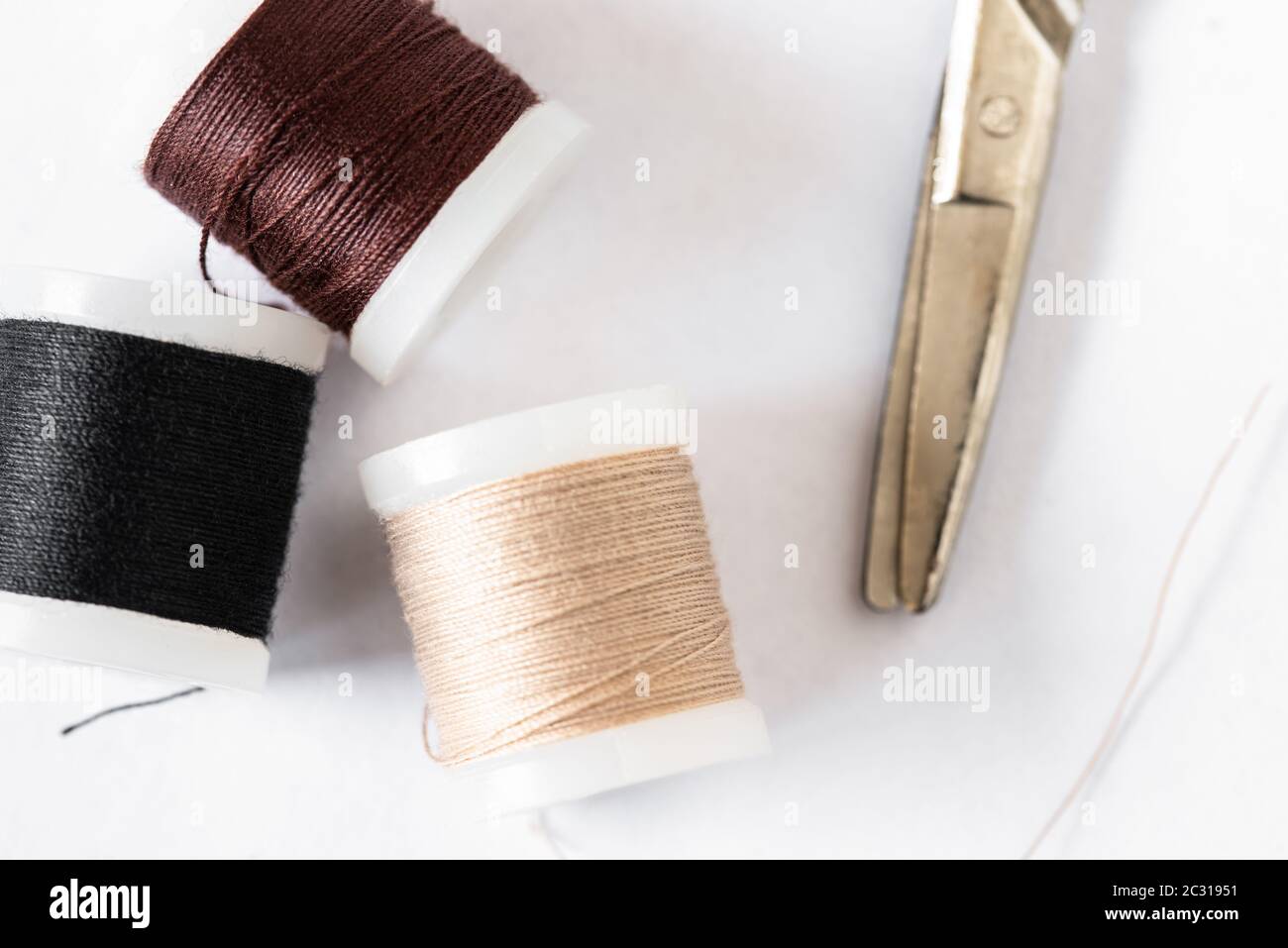 Black, Brown, and Cream Thread and Scissors Stock Photo - Alamy