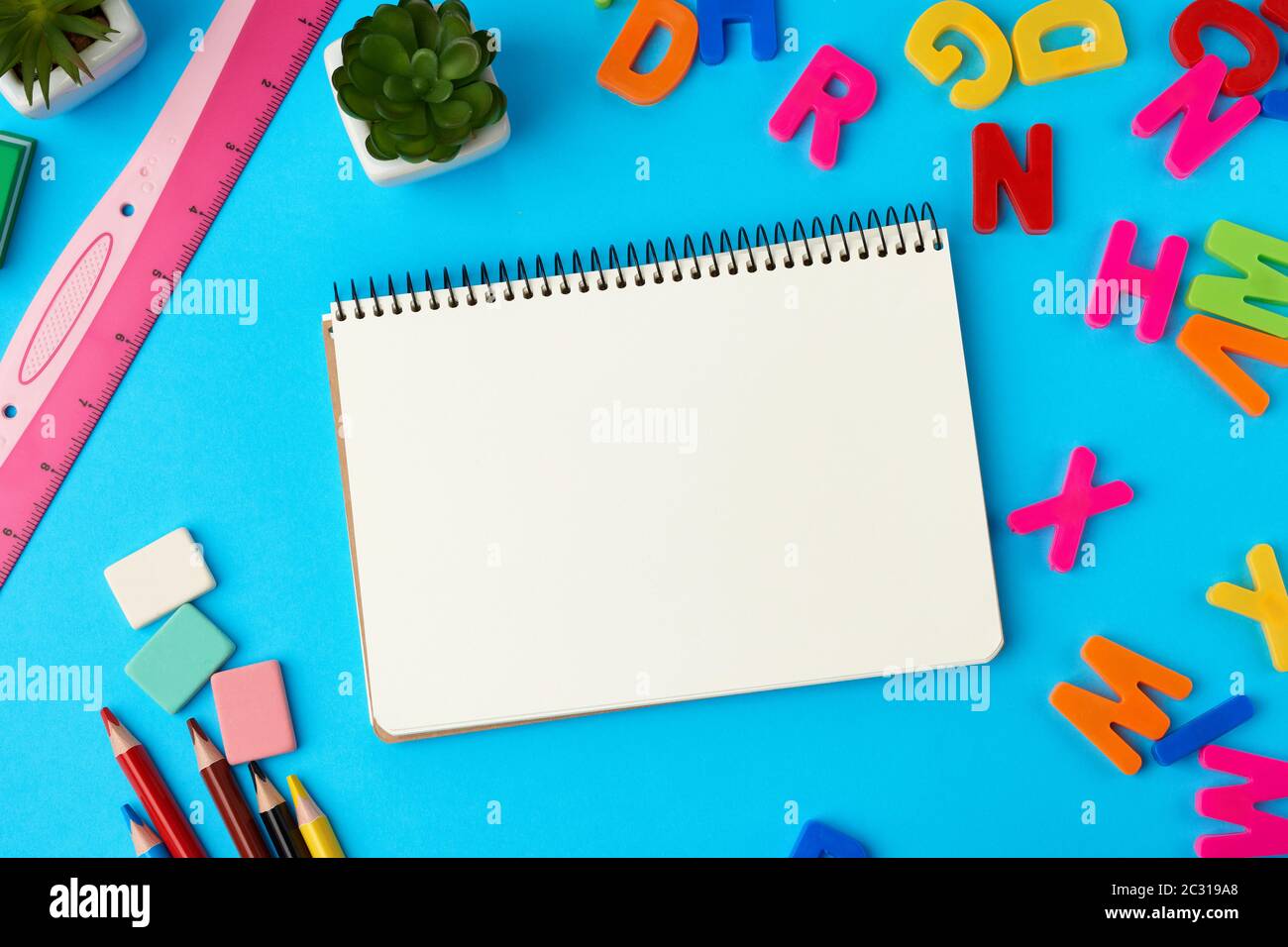 set of different school colorful items for learning at school on a blue ...