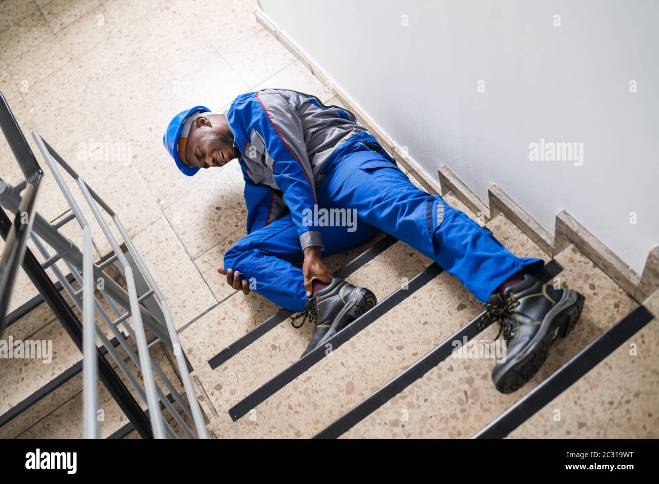 Handyman Touching His Injured Leg After Falling From Ladder Stock Photo ...