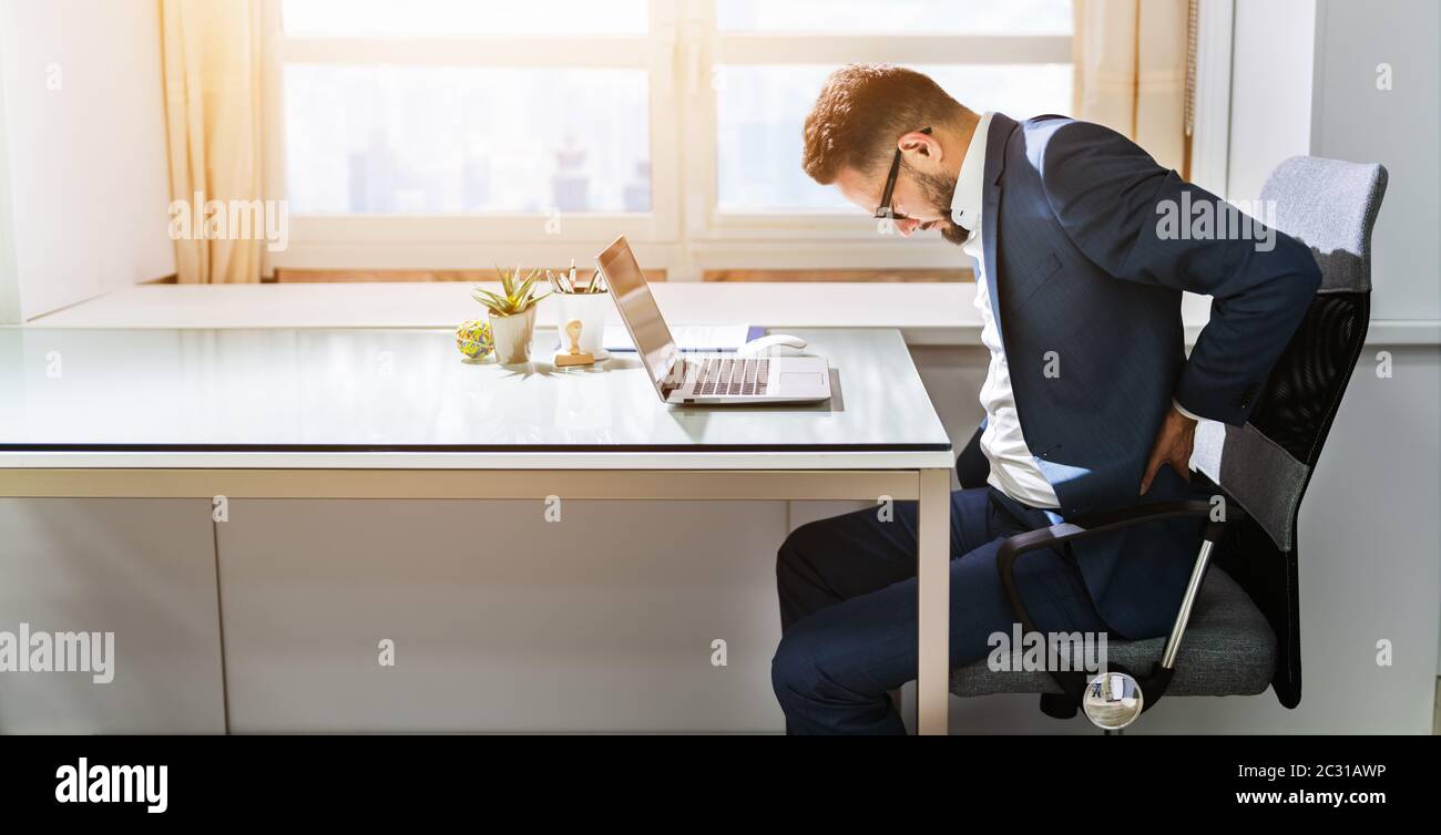 Side View Of A Businessman Suffering From Back Pain In Office Stock ...