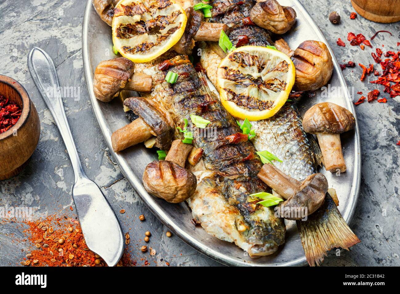 Baked whole pelengas fish with mushrooms and lemon.Sea food.Grilled ...