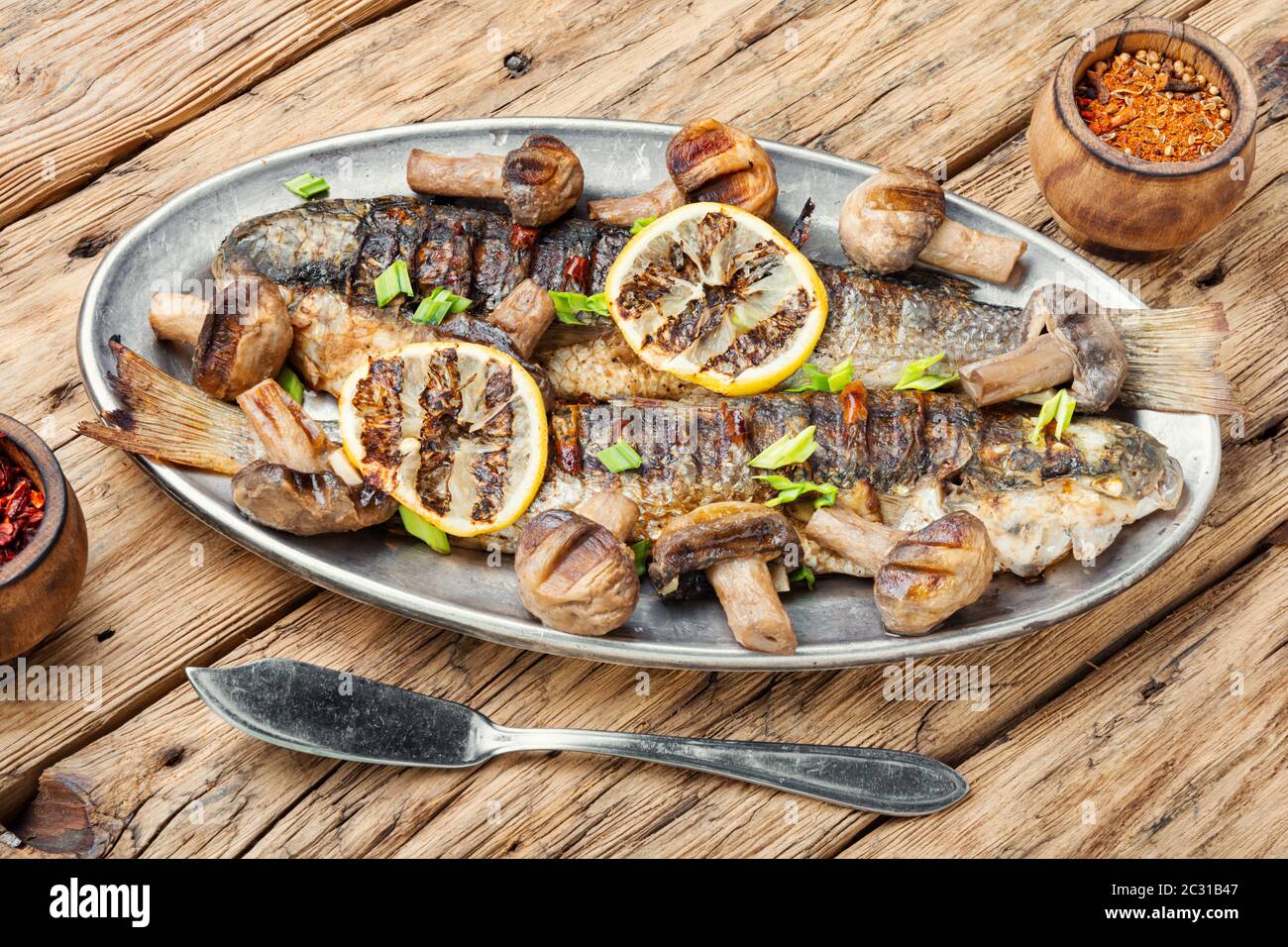 Baked whole pelengas fish with mushrooms and lemon.Sea food.Grilled ...