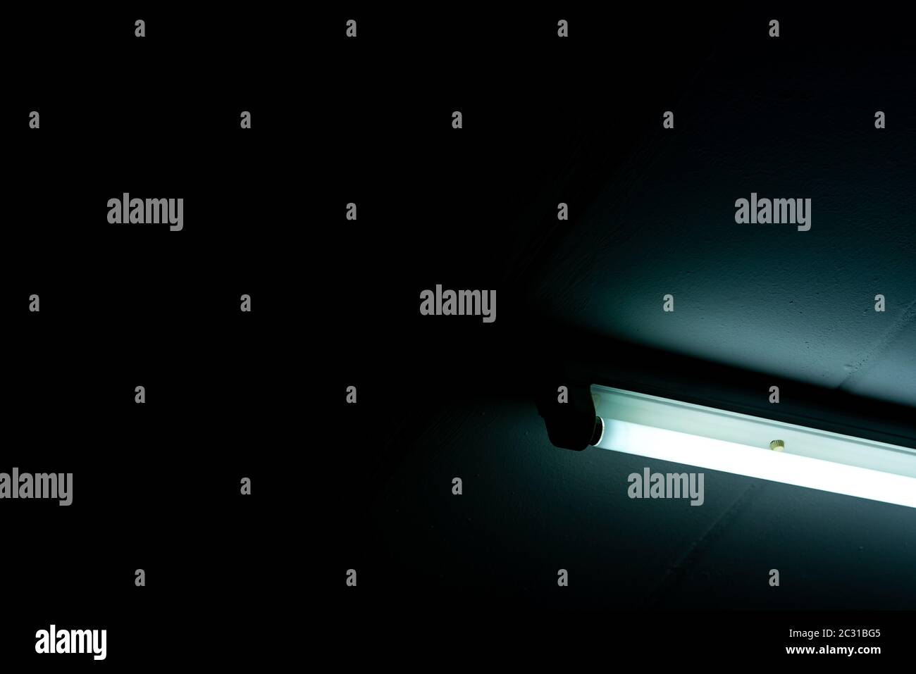 Opened LED light tube on dark background. LED fluorescent lamp light ...