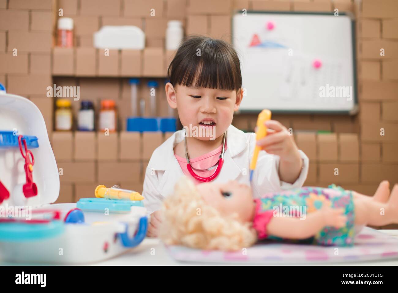 toddler girl pretend play doctor role at home Stock Photo - Alamy