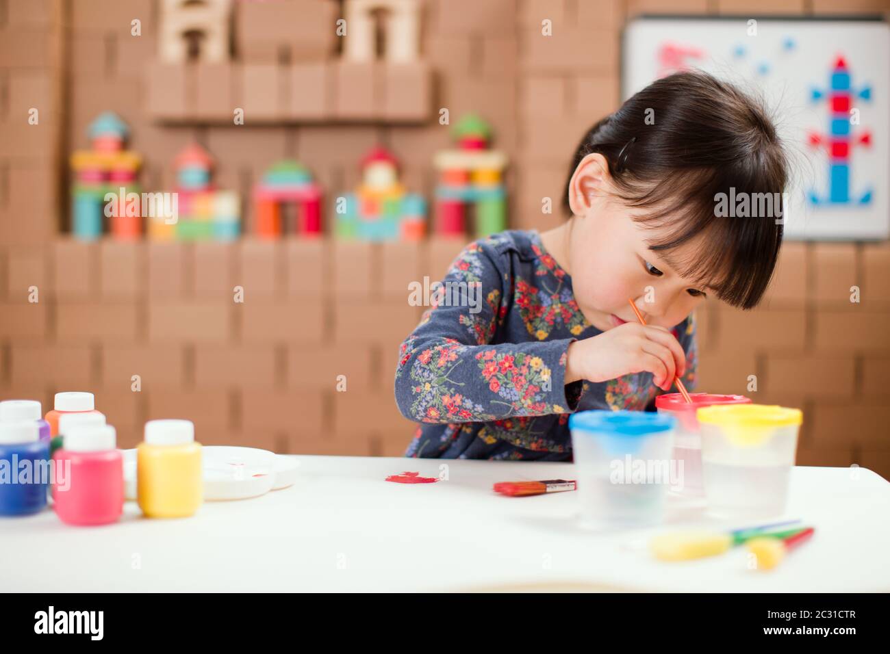 toddler girl practice color painting at home Stock Photo - Alamy