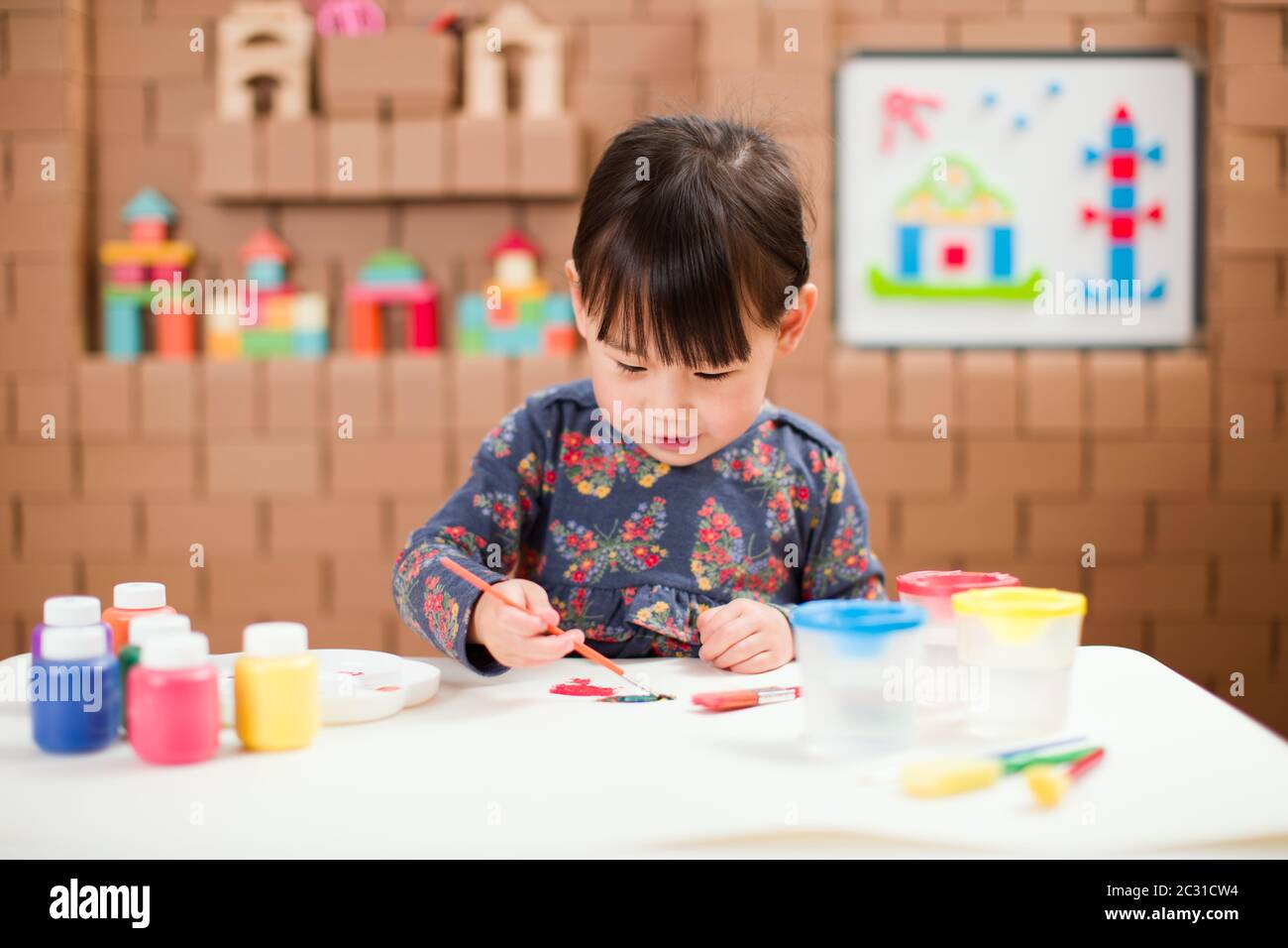 toddler girl practice color painting at home Stock Photo - Alamy