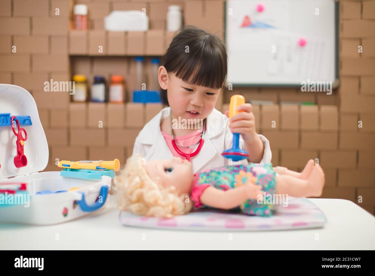 toddler girl pretend play doctor role at home Stock Photo - Alamy