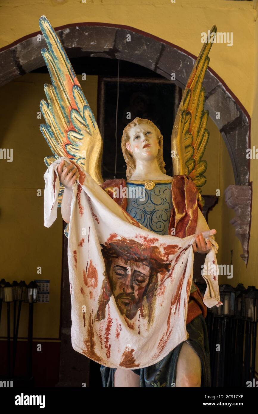 Statues of angels and saints line the hallways of the Oratorio Church ...