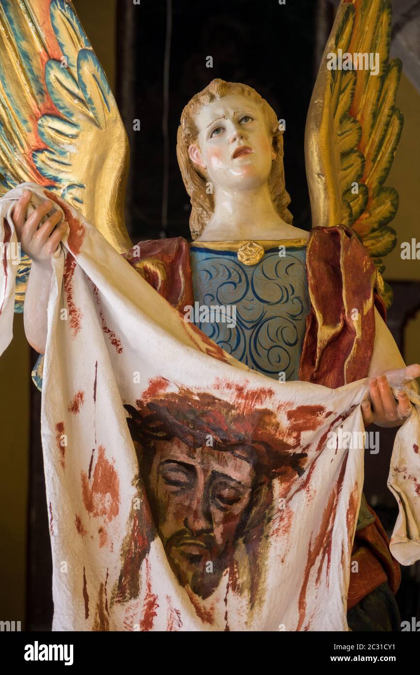 Statues of angels and saints line the hallways of the Oratorio Church ...