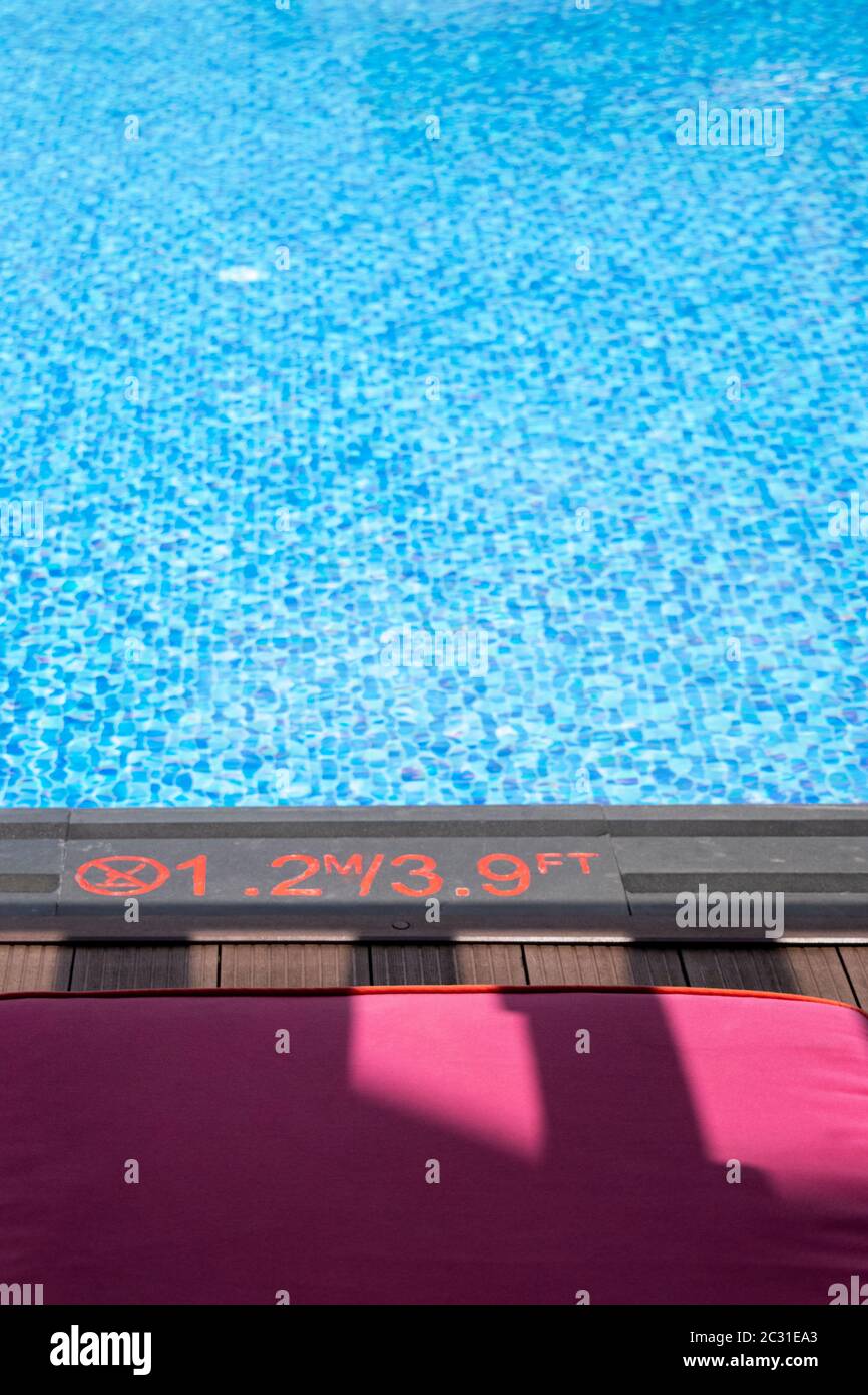 depth indicator blue mosaic tiles on the edge of swimming pool of the ...