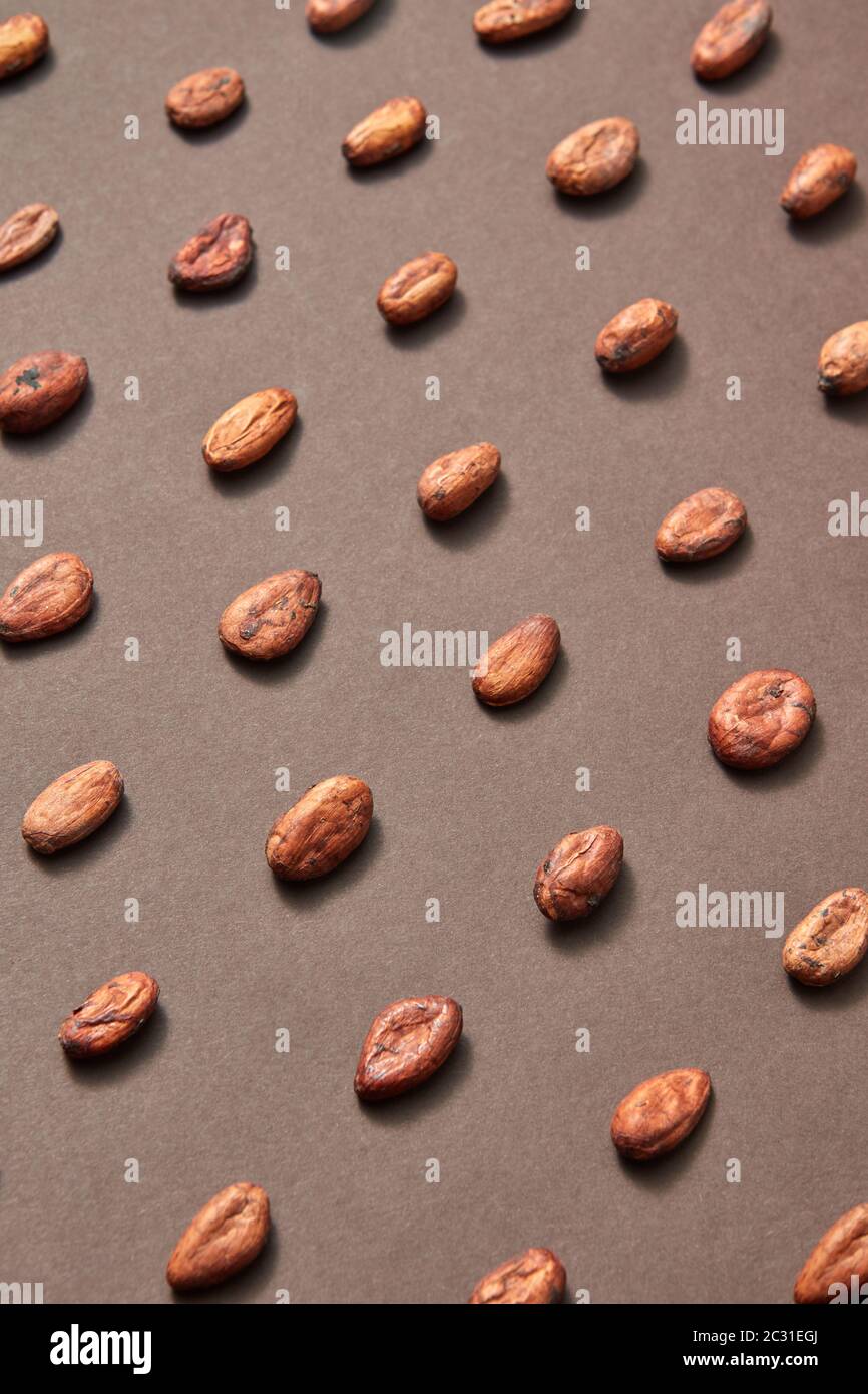Organic cocoa beans pattern on a brown background Stock Photo - Alamy