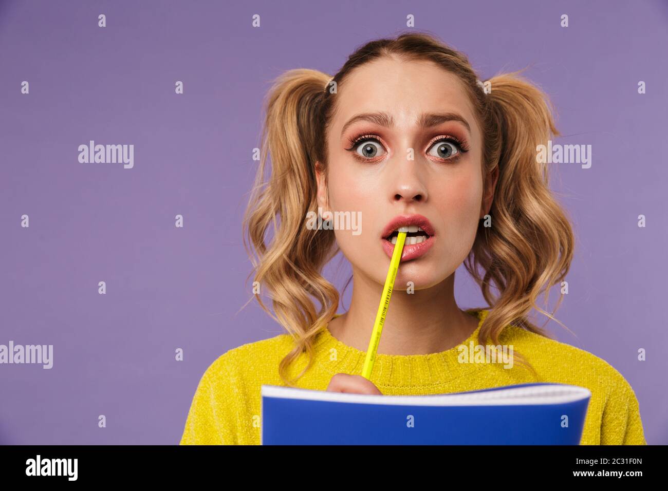 Image of shocked pretty woman with two tails posing with exercise book ...