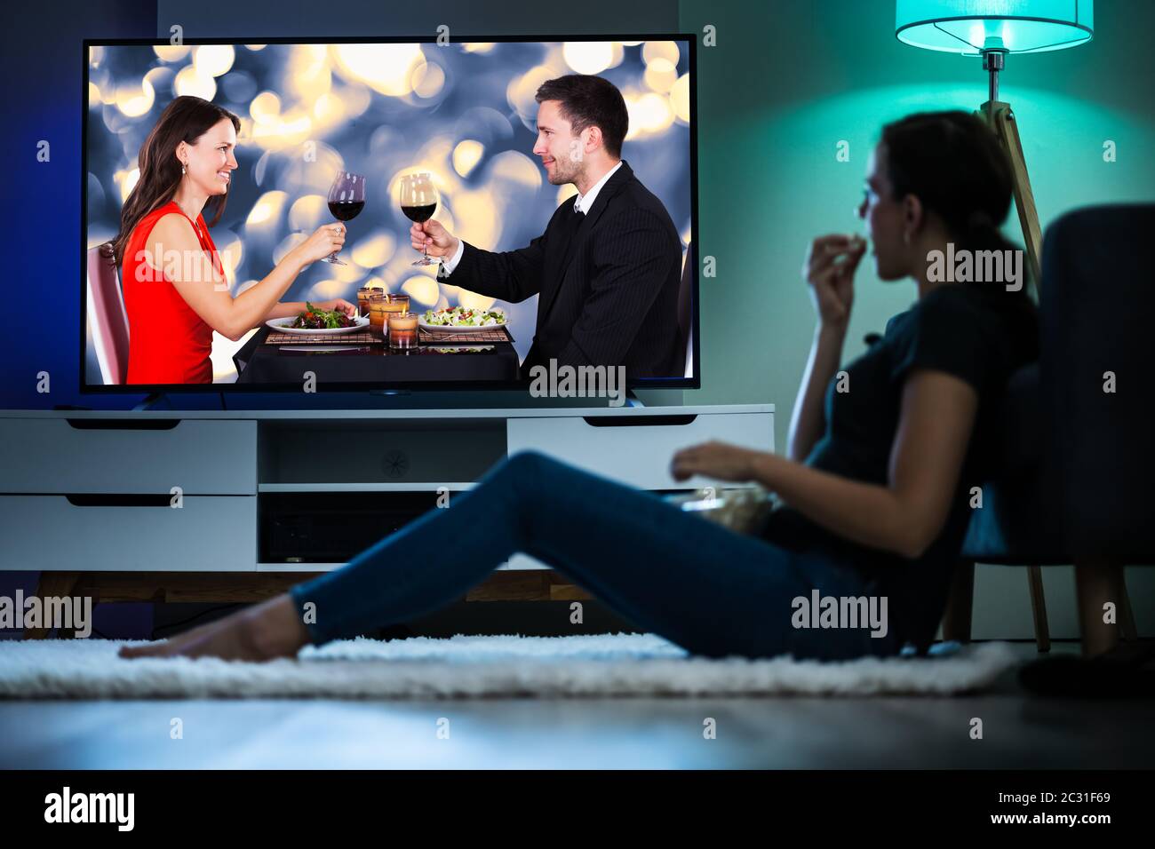 Woman Watching TV On Couch Or Sofa. Watch Television Stock Photo - Alamy