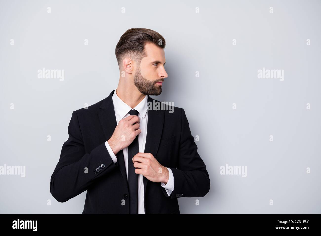 Profile side photo of serious handsome collar man adjust his tie ready ...