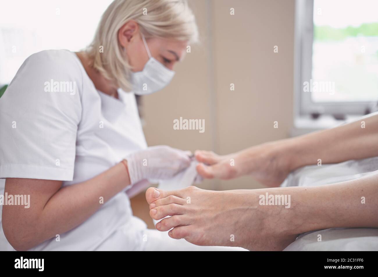 Pedicurist doing professional medical pedicure procedure in beauty ...