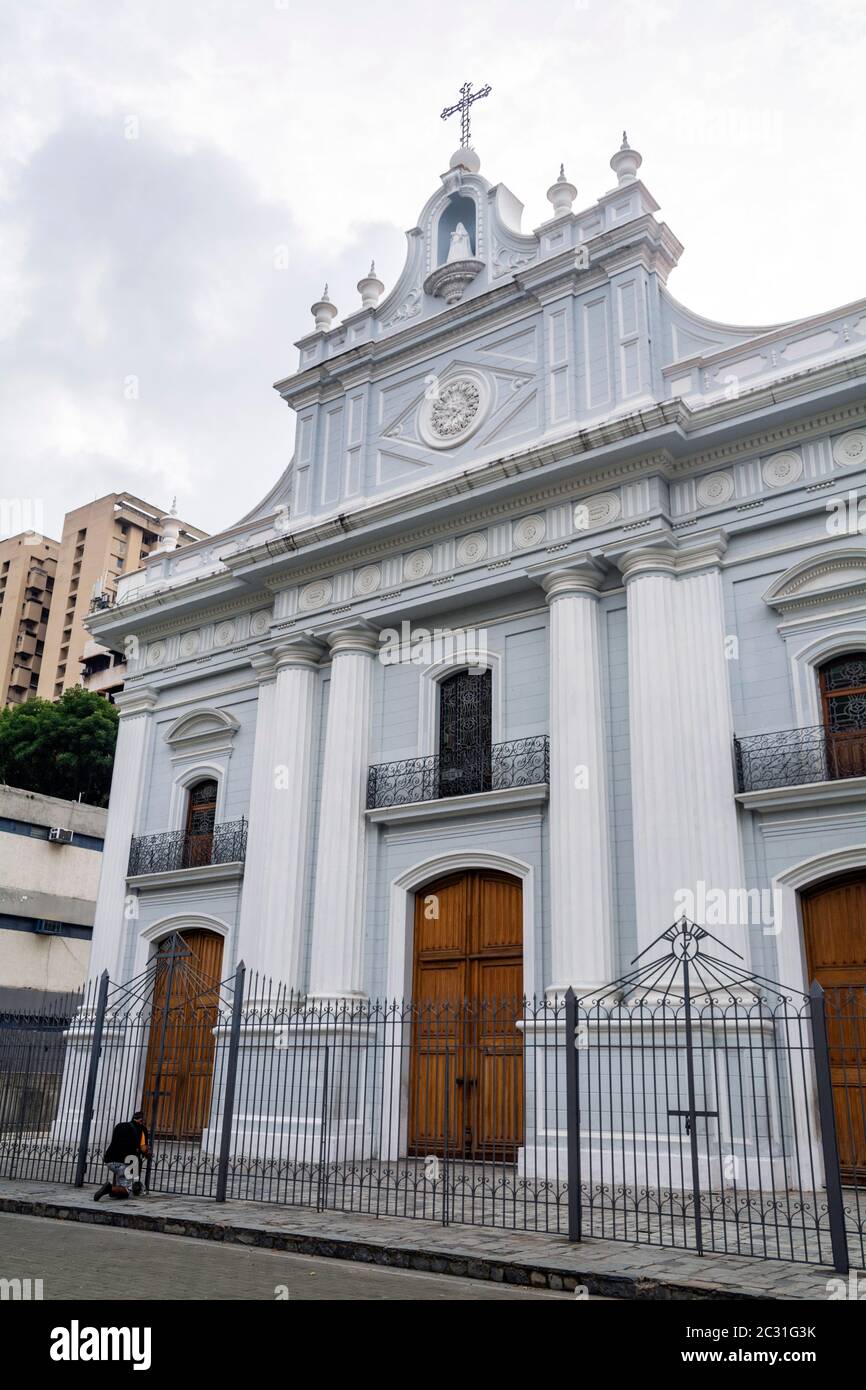 A man kneels and prays in front of the Church of Our Lady of Candelaria ...