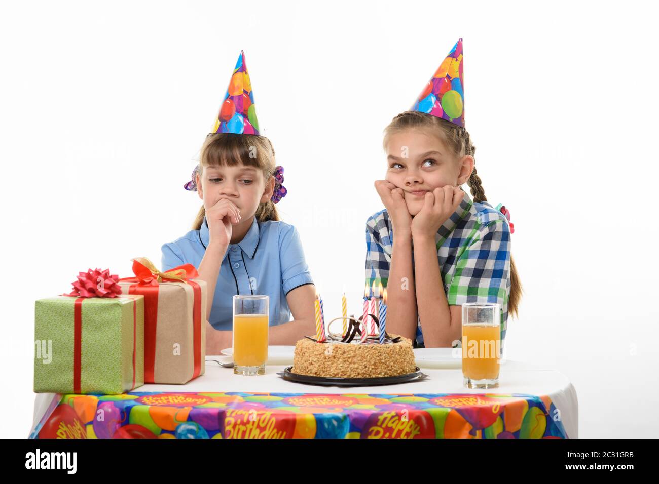 Two girls dream sitting at the festive table on the birthday Stock ...