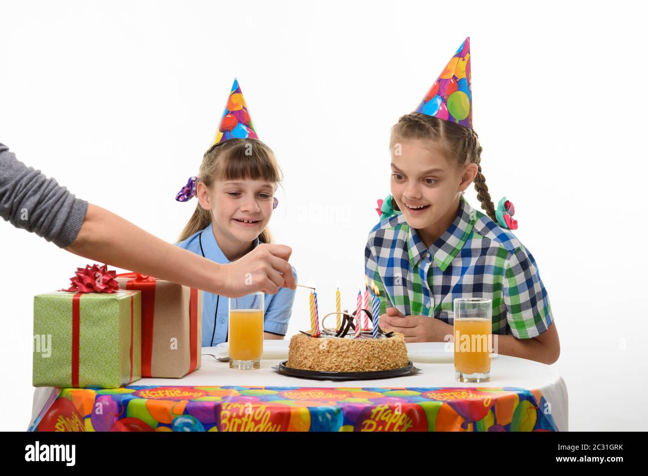Mom S Hand Sets Fire To Candles On A Birthday Cake Stock Photo Alamy