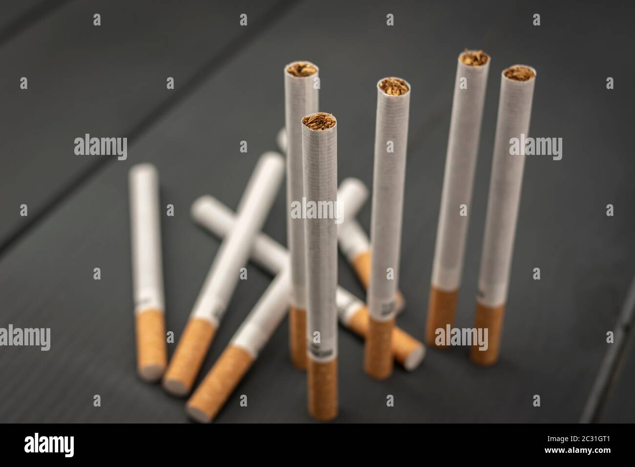 Cigarettes arranged vertically and horizontally focused on tobacco on ...