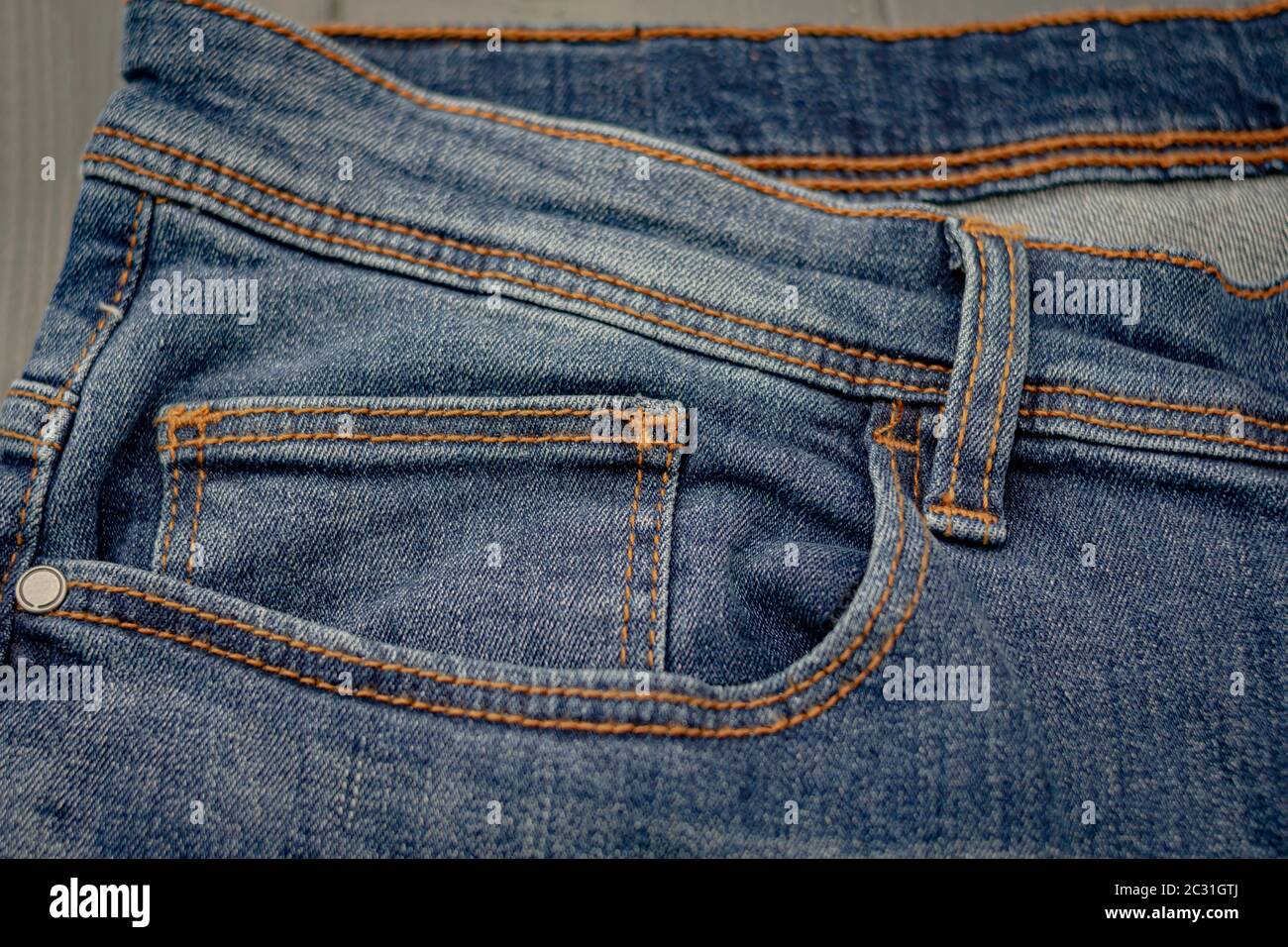 Front pockets of a washed blue denim pants Stock Photo - Alamy