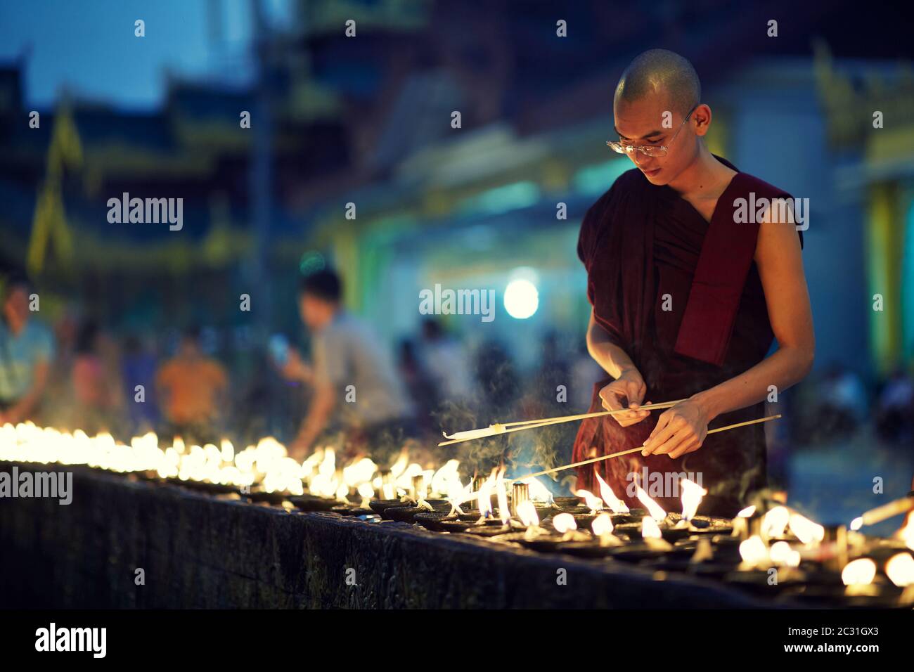 Buddhist monk with candle hi-res stock photography and images - Alamy