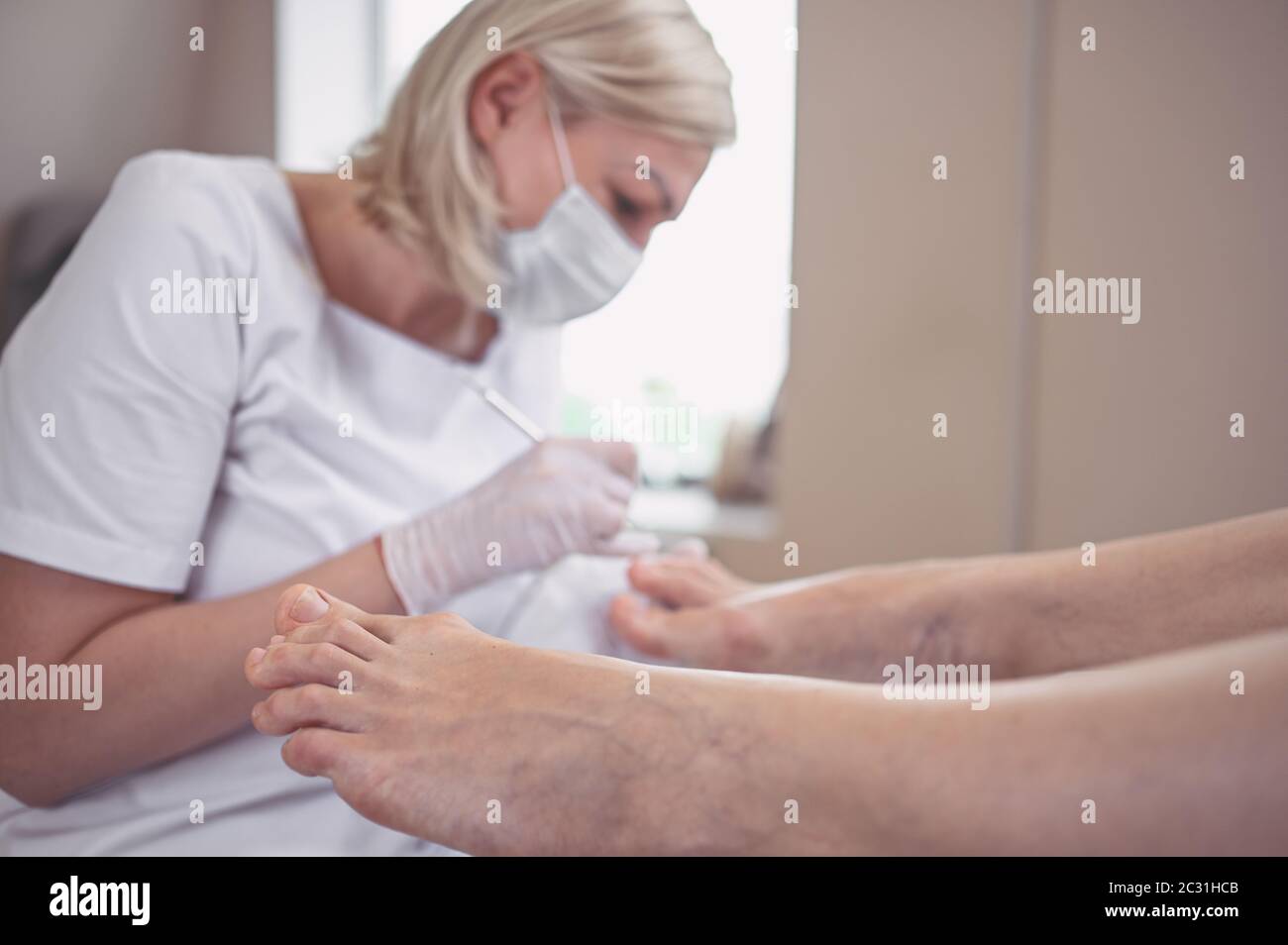 Professional medical pedicure procedure close up using double nail ...