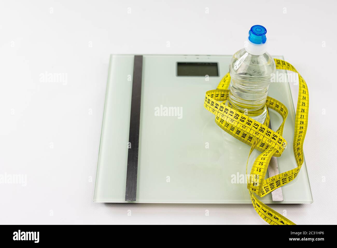 Scale for dieting, bottled mineral water and a measuring tape Stock ...