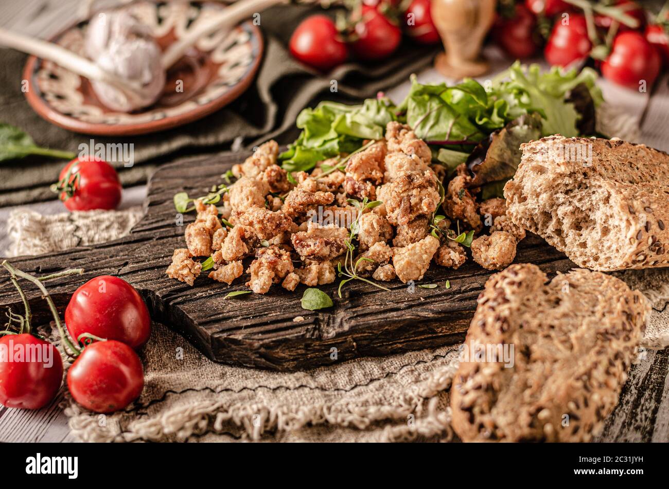 Delicious fat food, fried greaves pork with garlic Stock Photo - Alamy