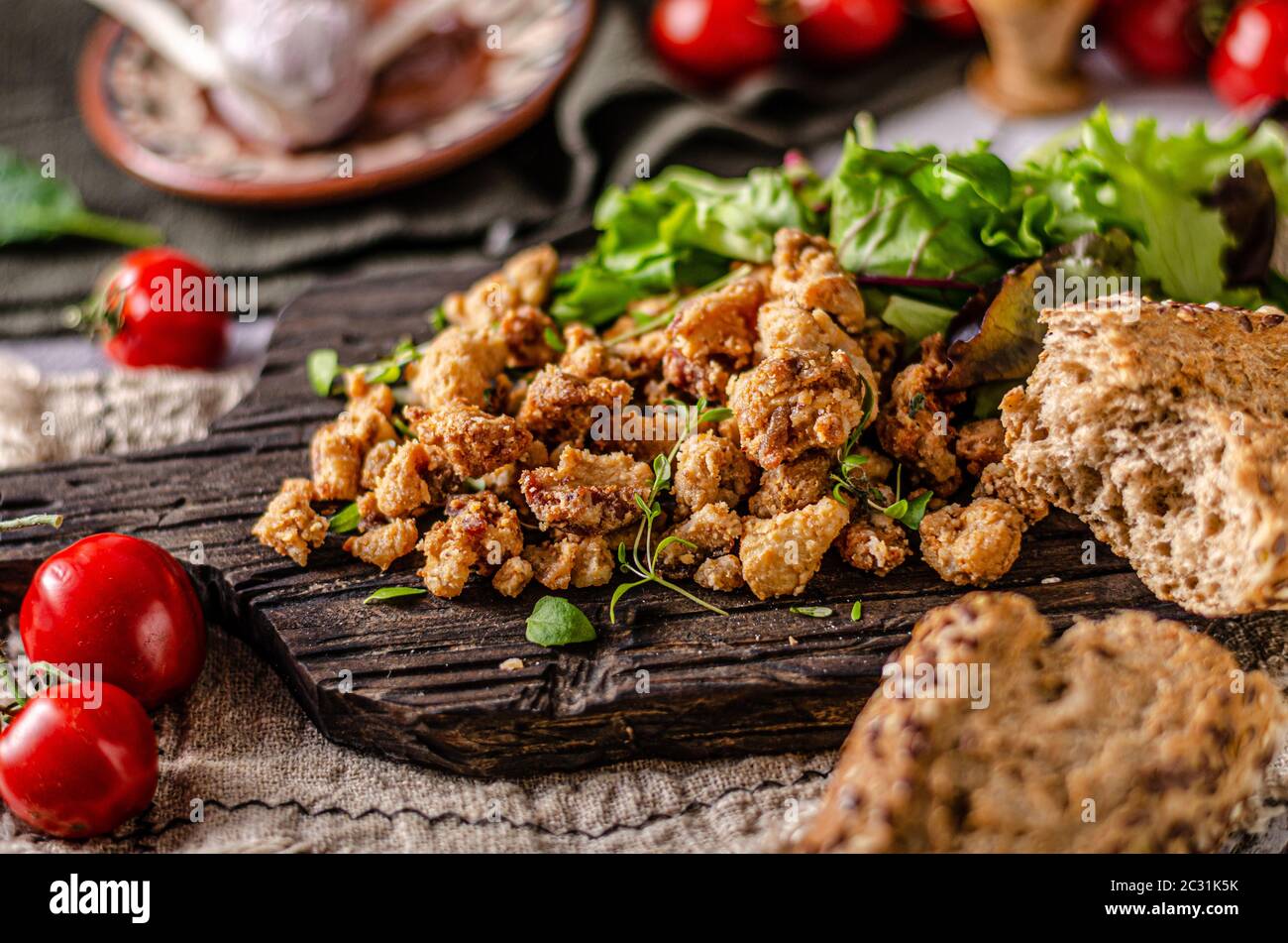 Delicious fat food, fried greaves pork with garlic Stock Photo - Alamy