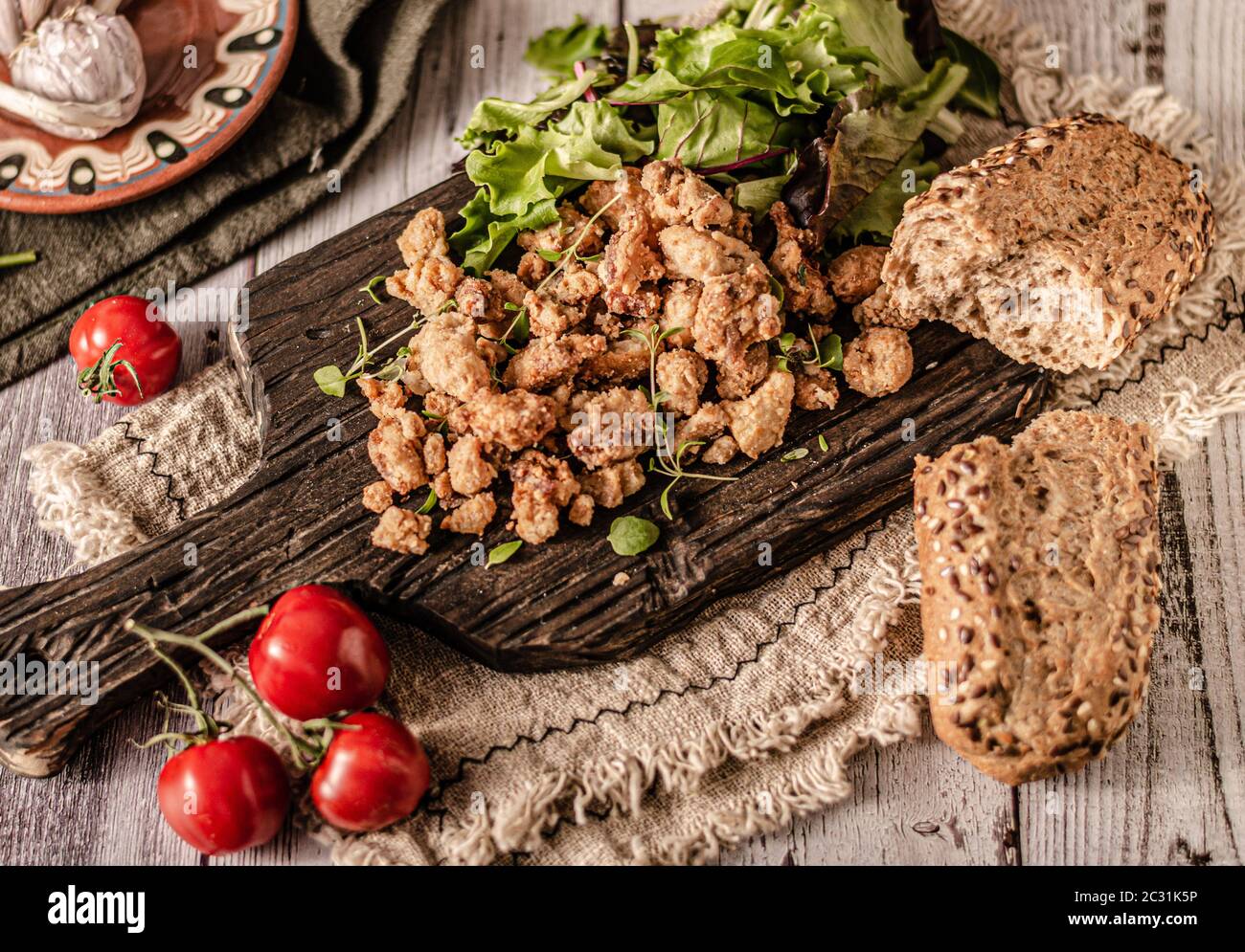 Delicious fat food, fried greaves pork with garlic Stock Photo - Alamy