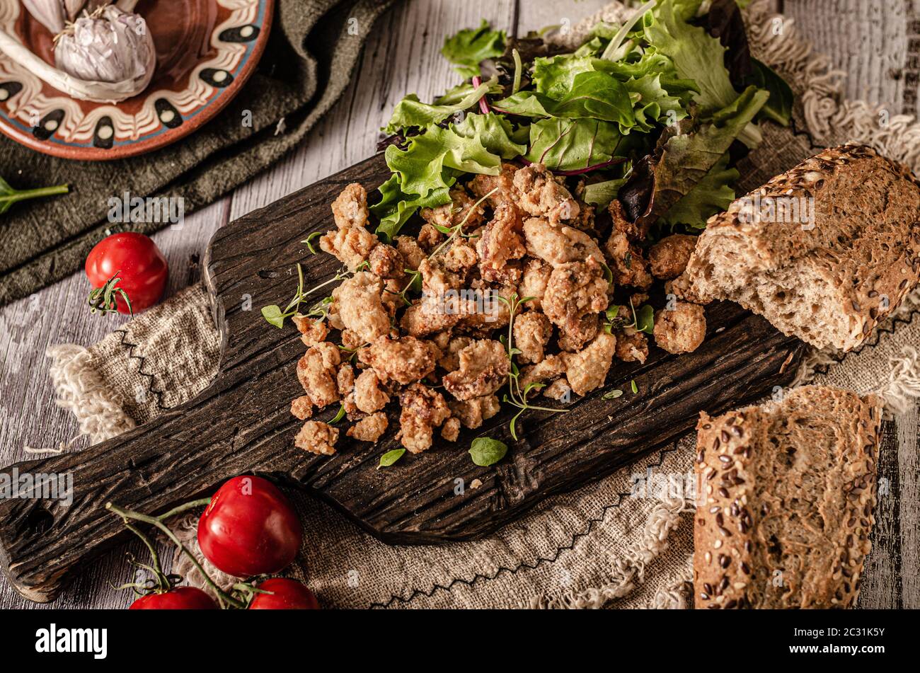 Delicious fat food, fried greaves pork with garlic Stock Photo - Alamy