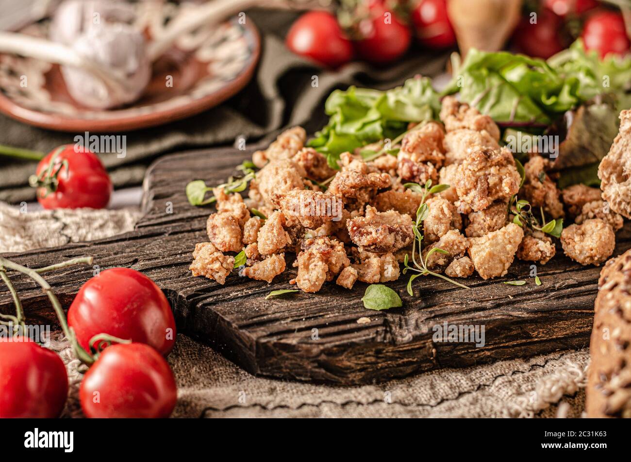 Delicious fat food, fried greaves pork with garlic Stock Photo - Alamy