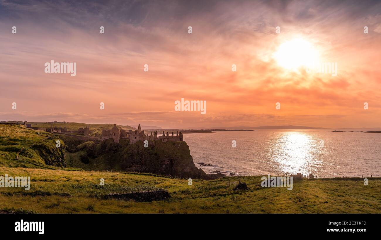 Dunluce Castle on the cliff in Bushmills, sunset Stock Photo - Alamy