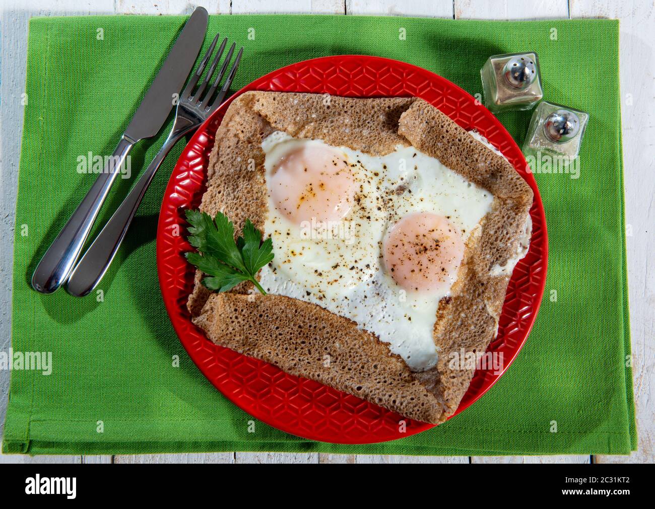 homemade Breton crepe with egg in a red plate Stock Photo - Alamy