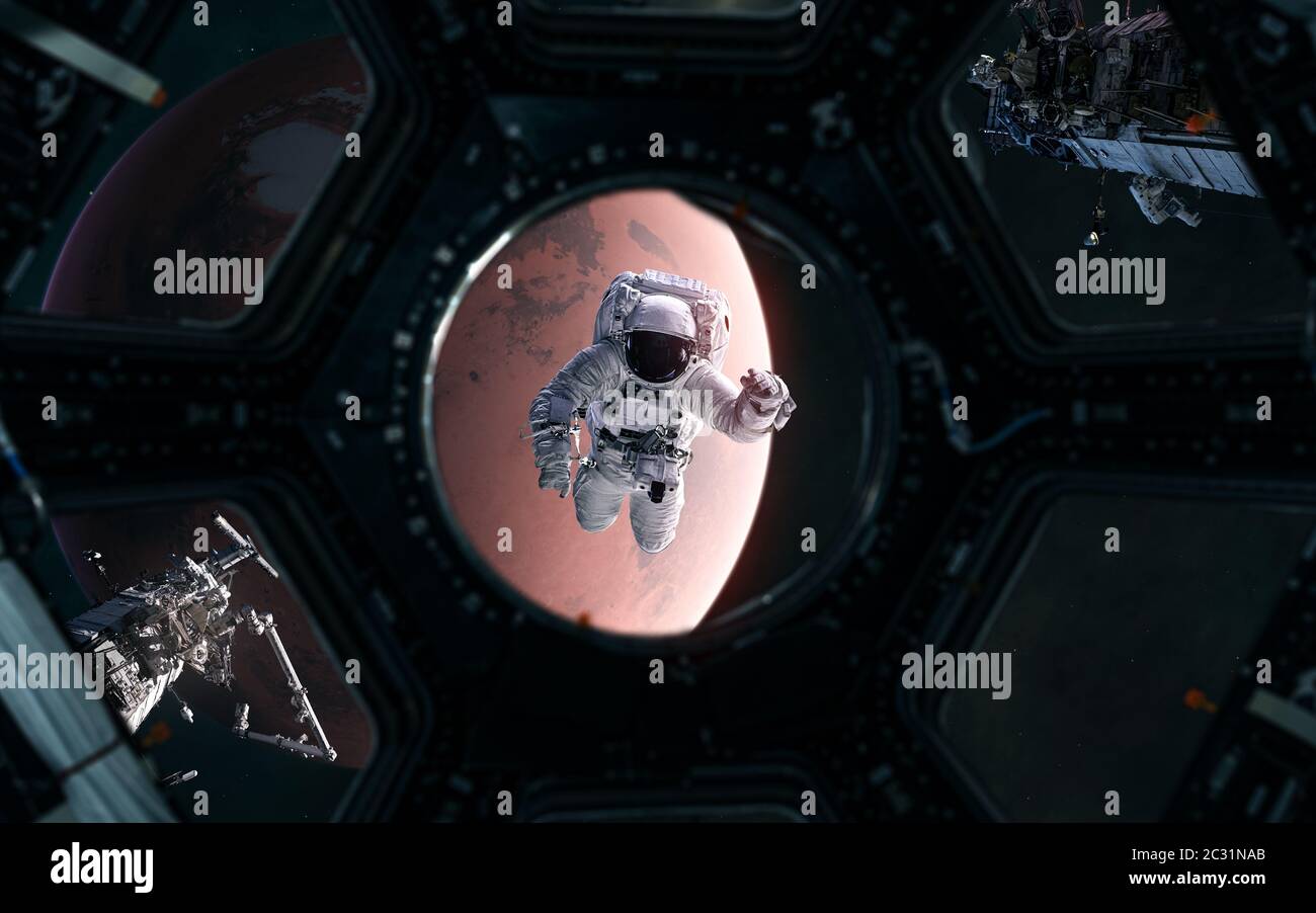 Astronaut on background of Mars. Solar system. View from porthole of ...