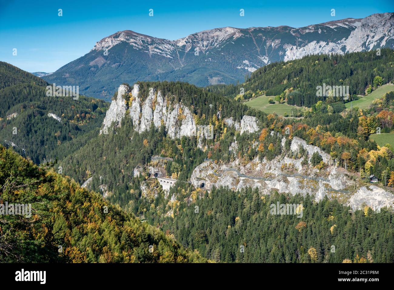 Viaduct and tunnel on the Semmering Railway with the Rax mountain range ...