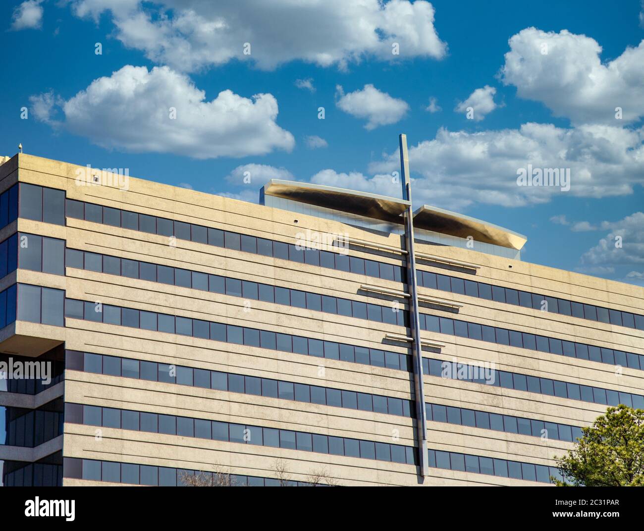 Metal cross shaped architectural detail on a concrete and blue glass ...